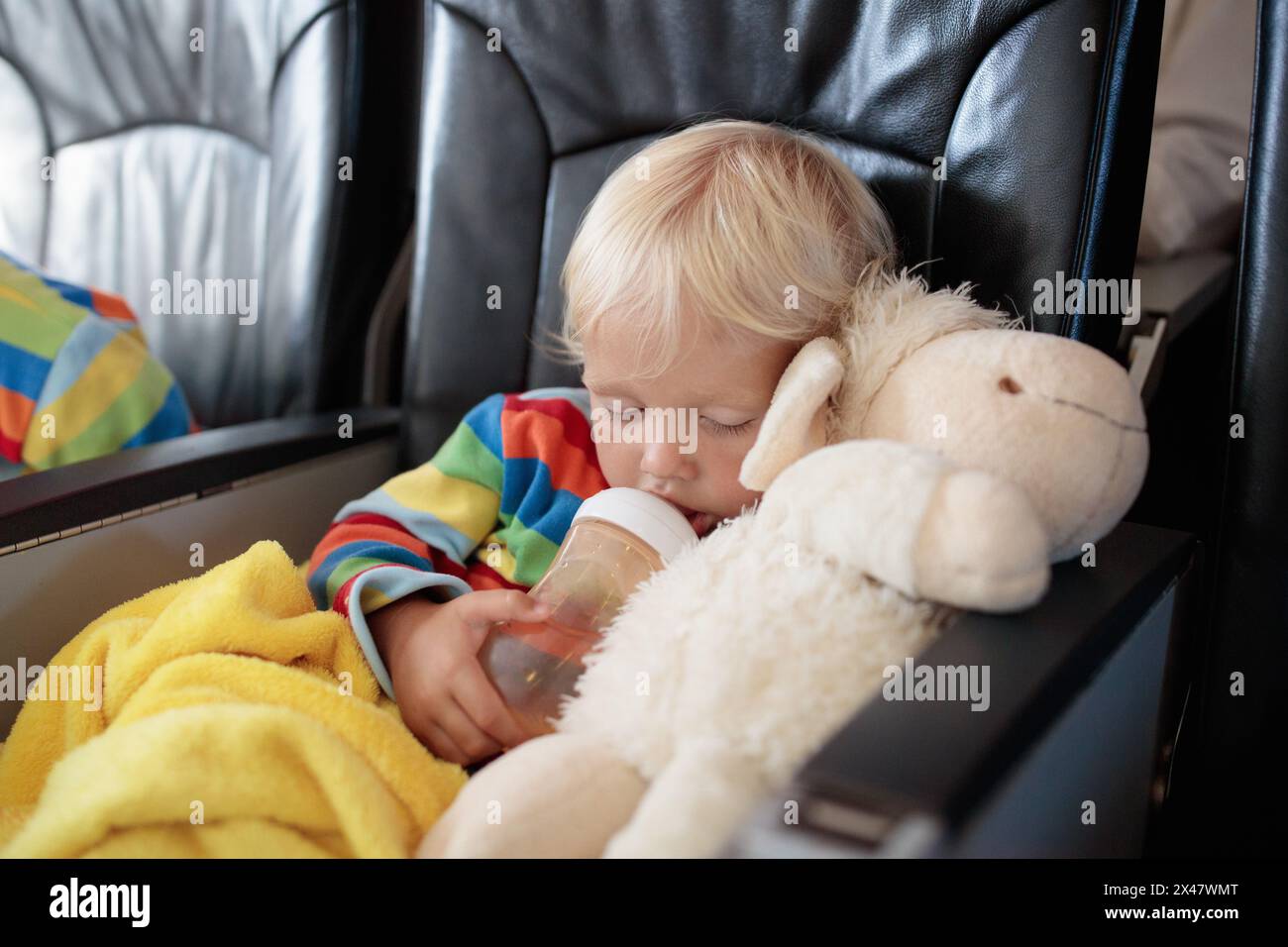 Child in airplane. Kid in air plane sitting in window seat. Flight ...