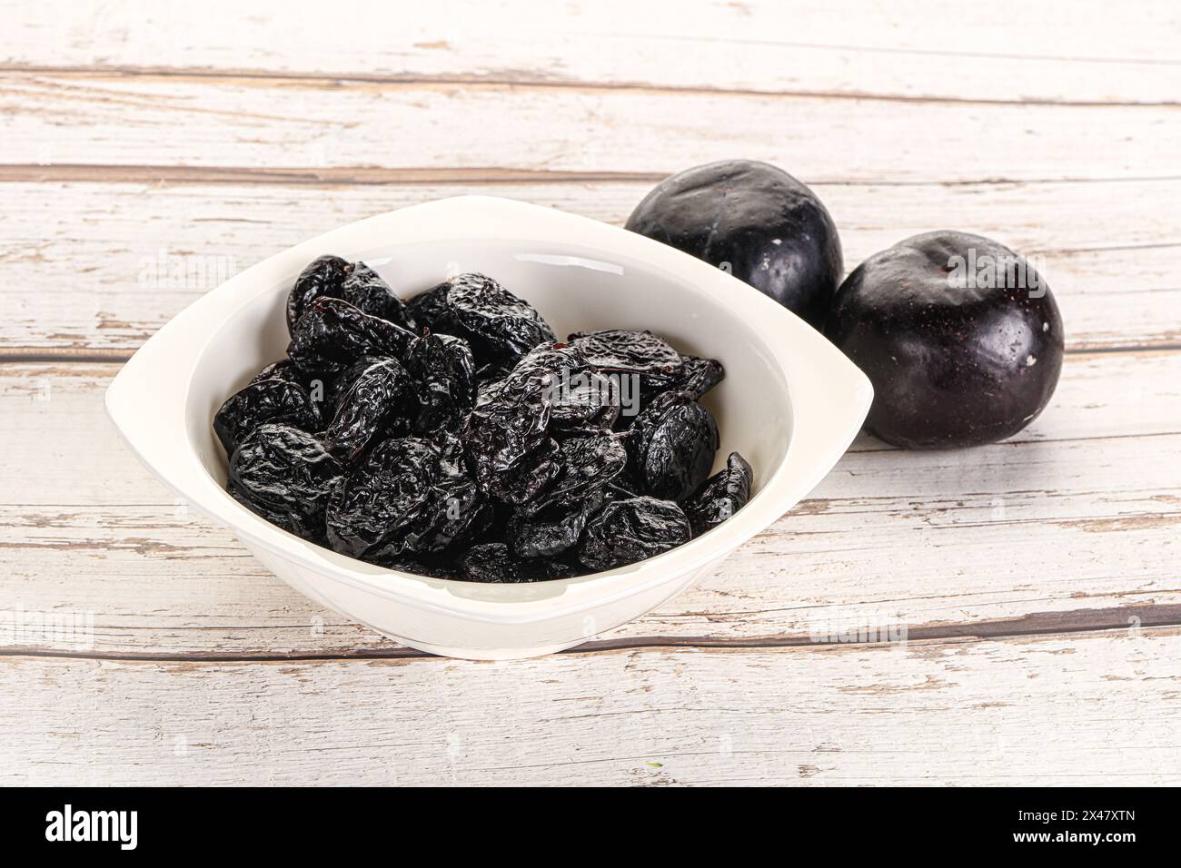 Dry sweet prunes in thw bowl Stock Photo - Alamy