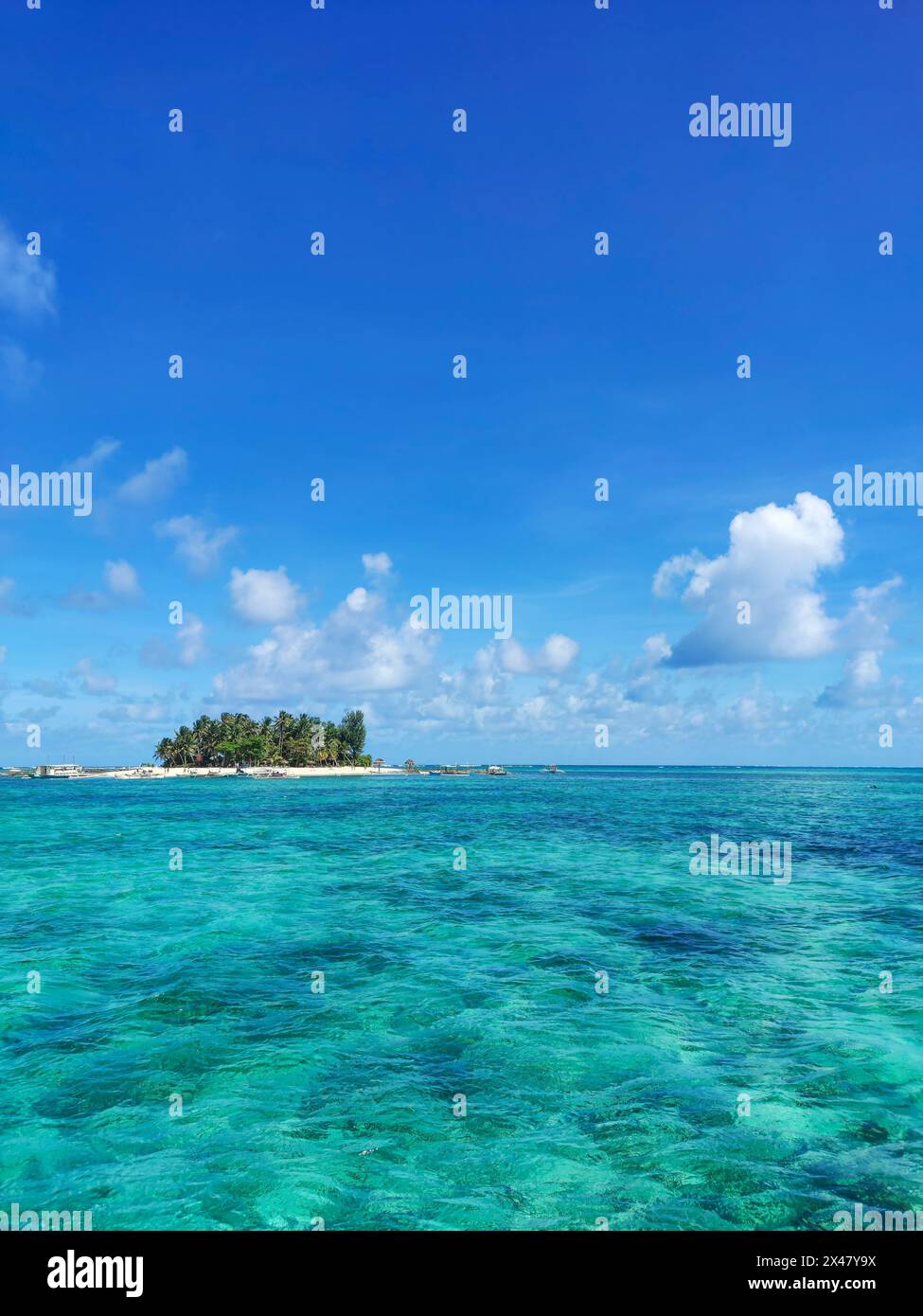 Translucent turquoise waters around a tiny island in Siargao, Mindanao ...