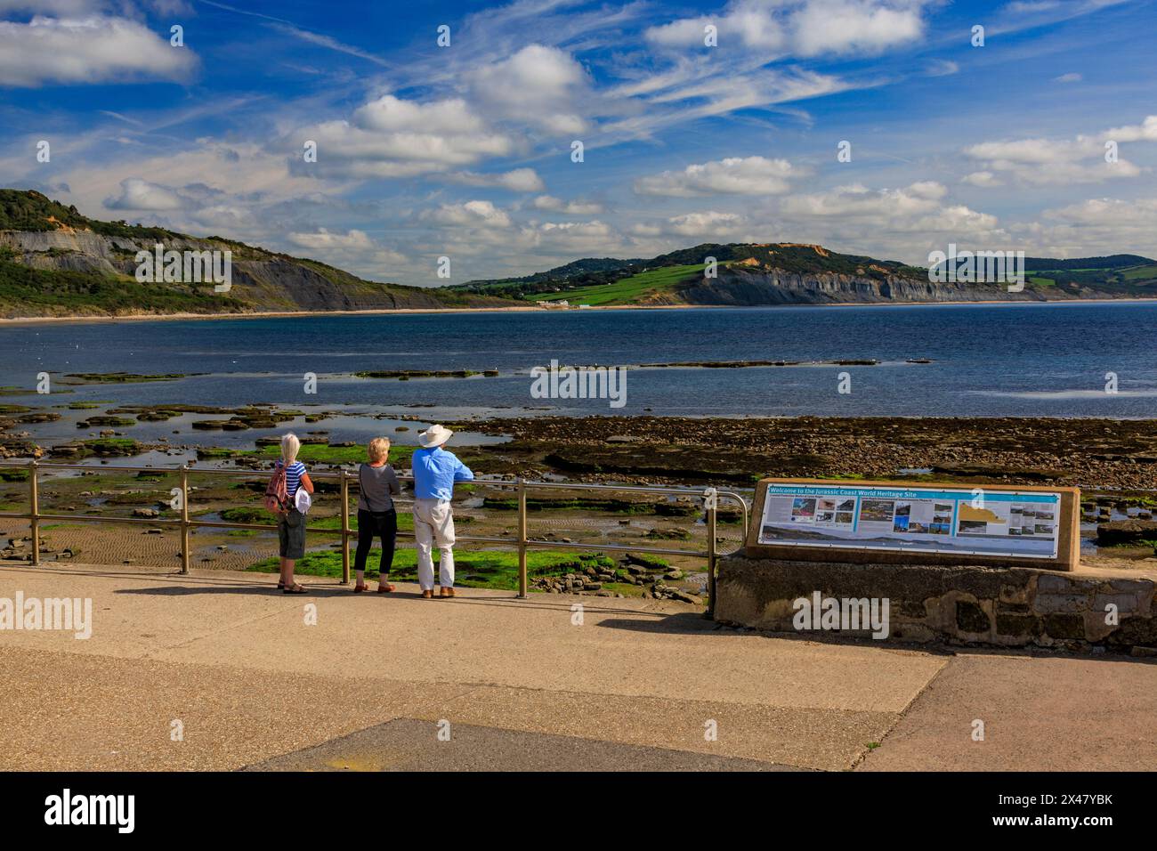 Three visitors looking at the massive landslip of the unstable cliffs ...