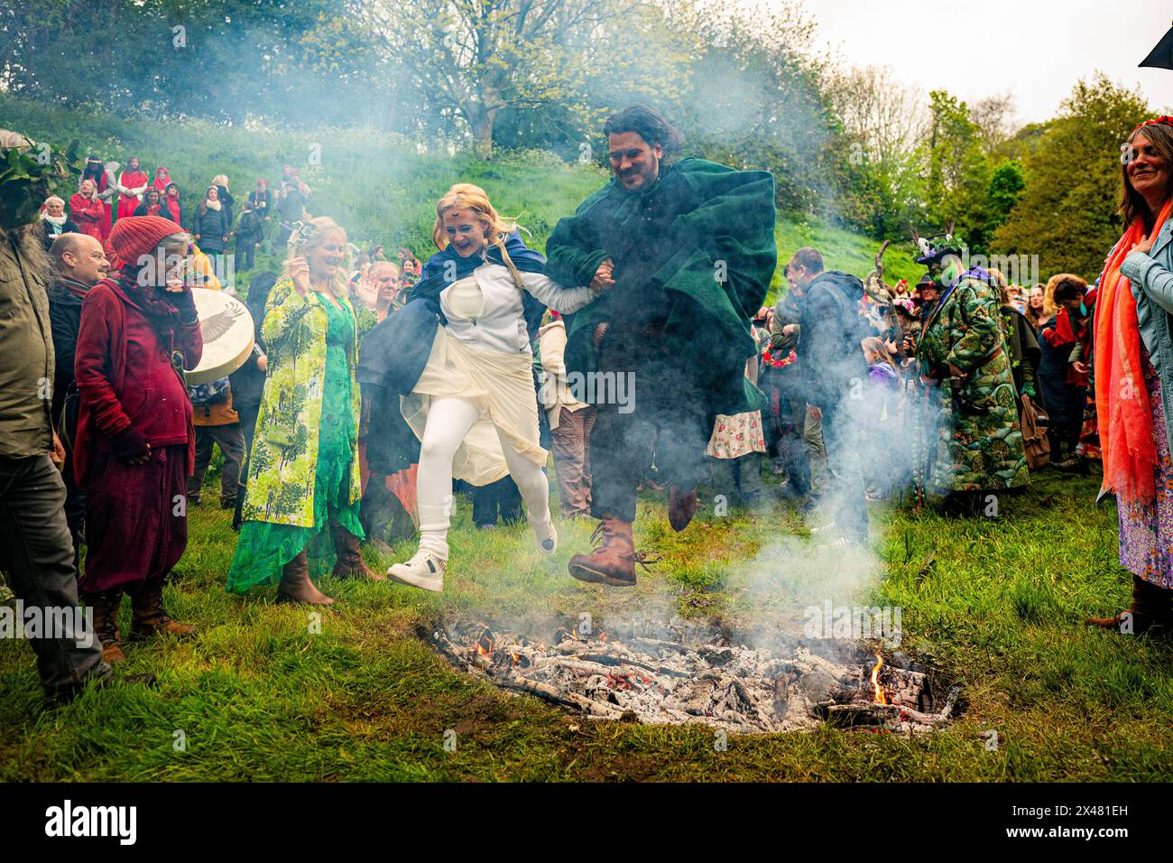 People jump the fire during the Beltane celebrations at Glastonbury ...