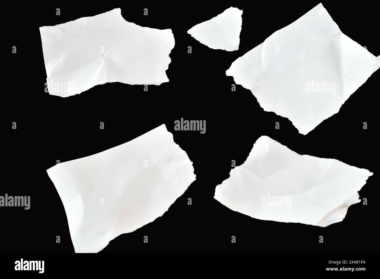 On a black background, four clean white paper sheets lie chaotically ...