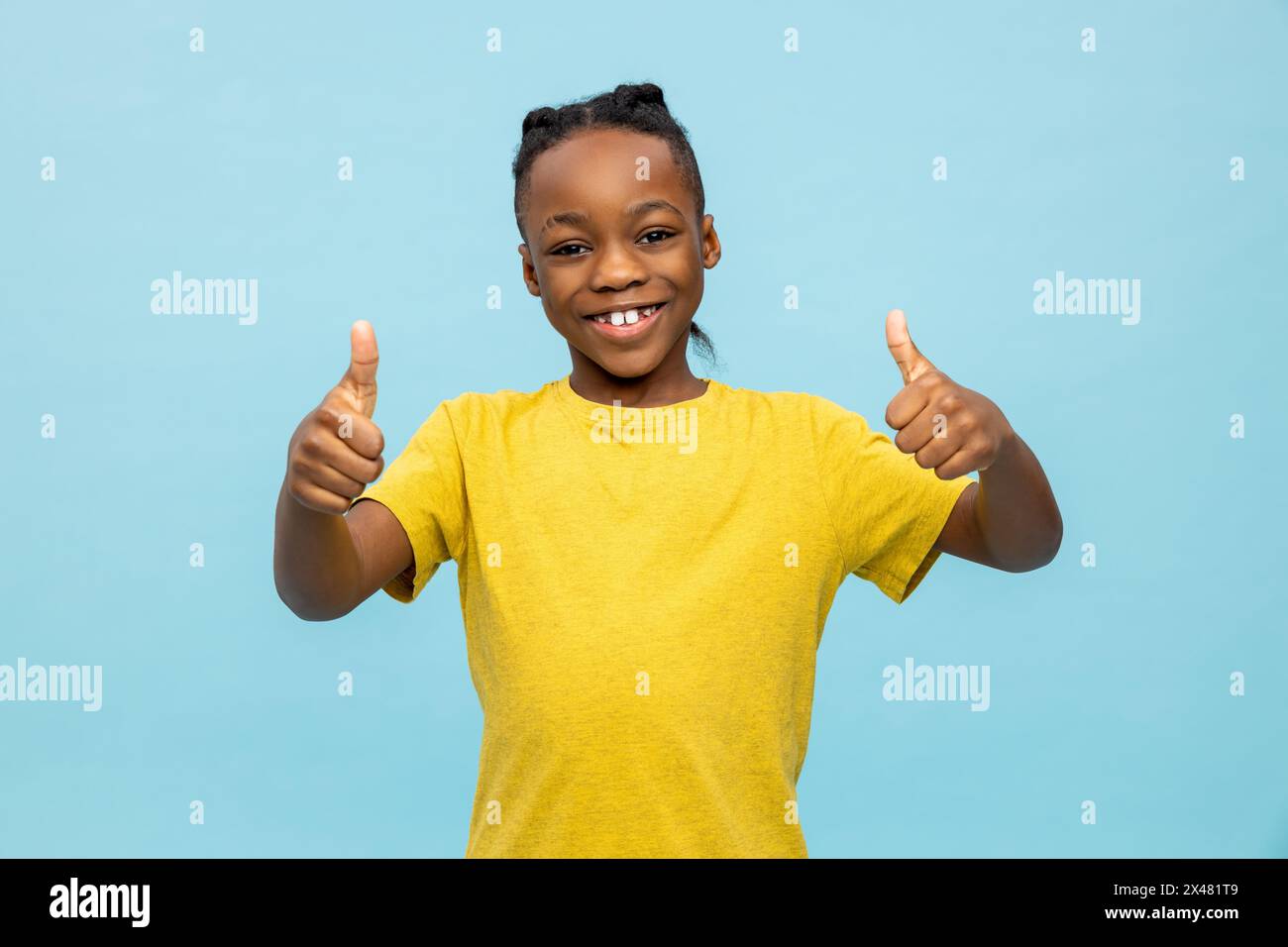 Cute dark-skinned boy looking excited and smiling nicely Stock Photo ...