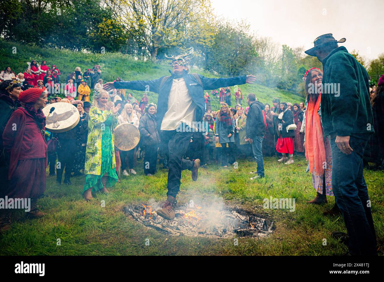 People jump the fire during the Beltane celebrations at Glastonbury ...
