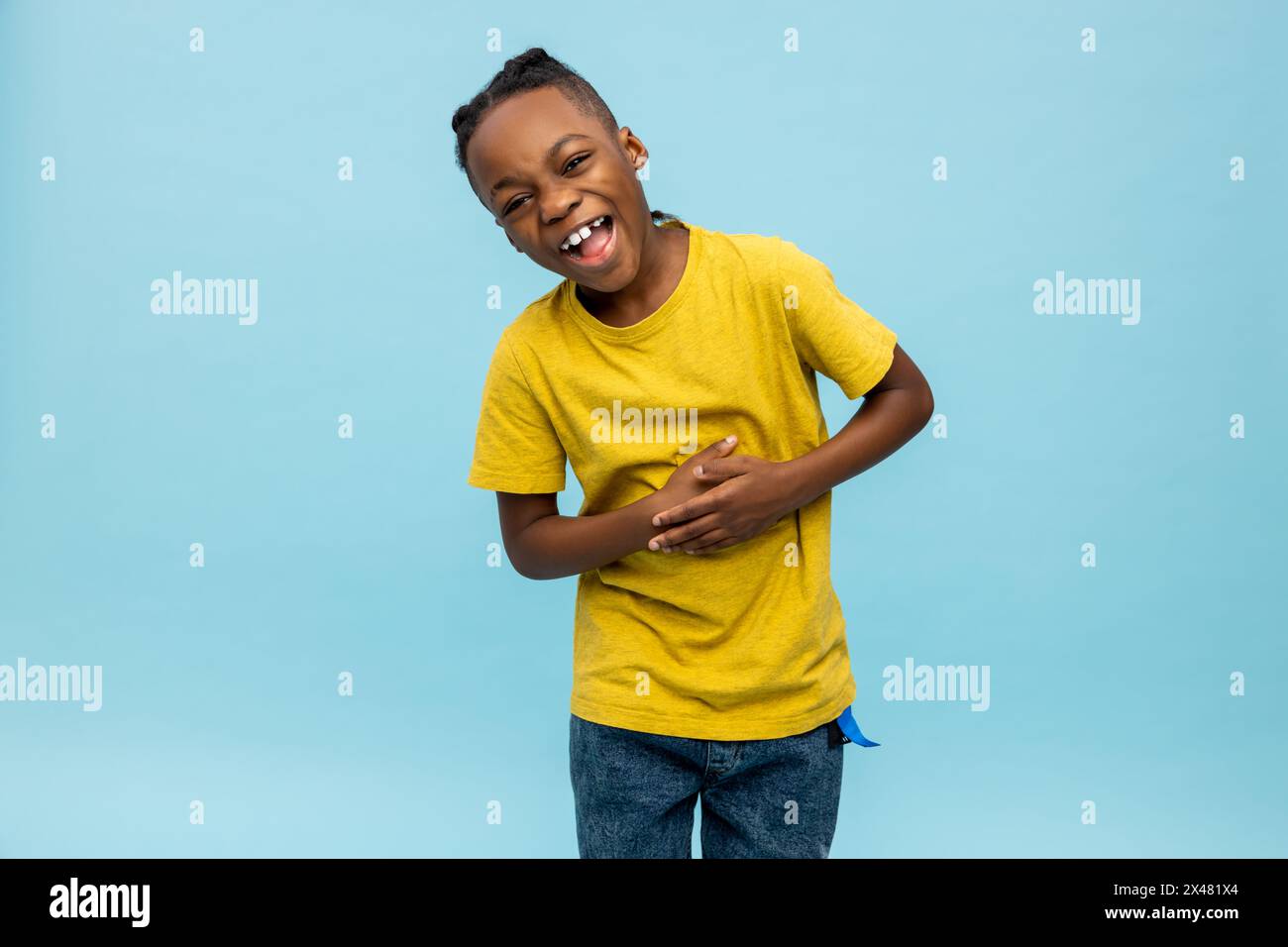 Cute dark-skinned boy laughing hard and looking enjoyed Stock Photo - Alamy