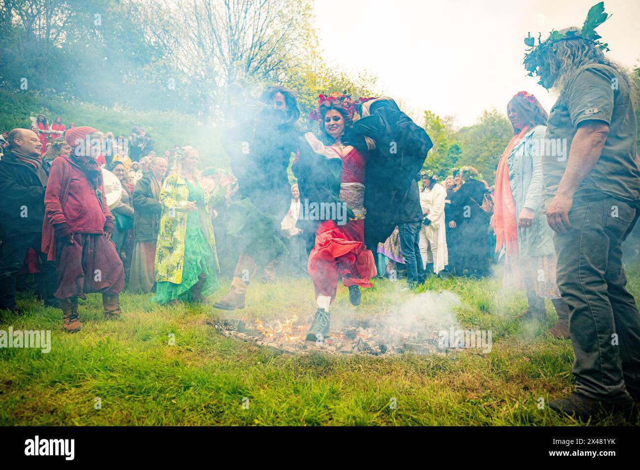 People jump the fire during the Beltane celebrations at Glastonbury ...