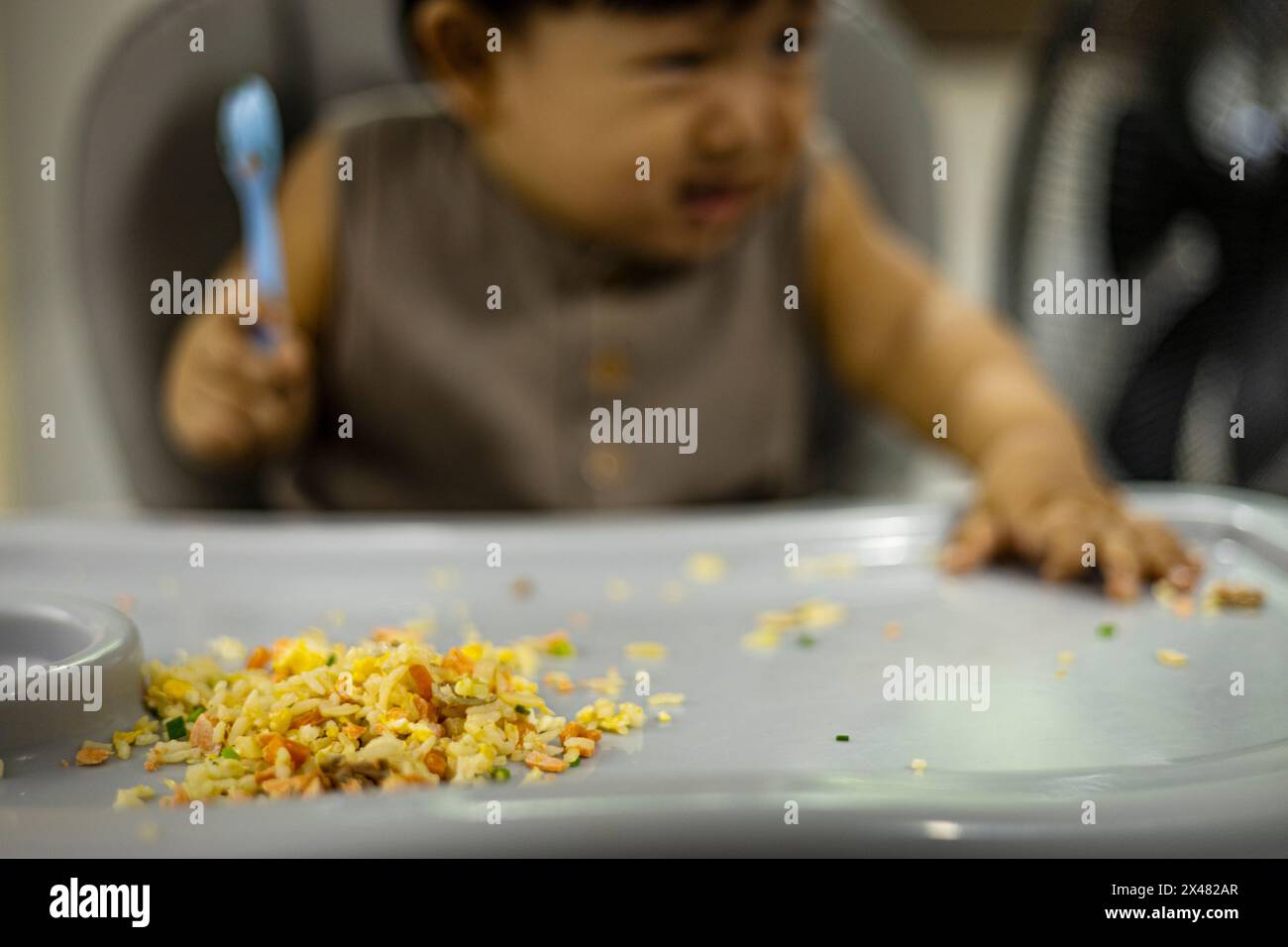 Little boy eating his food and making a mess Stock Photo - Alamy