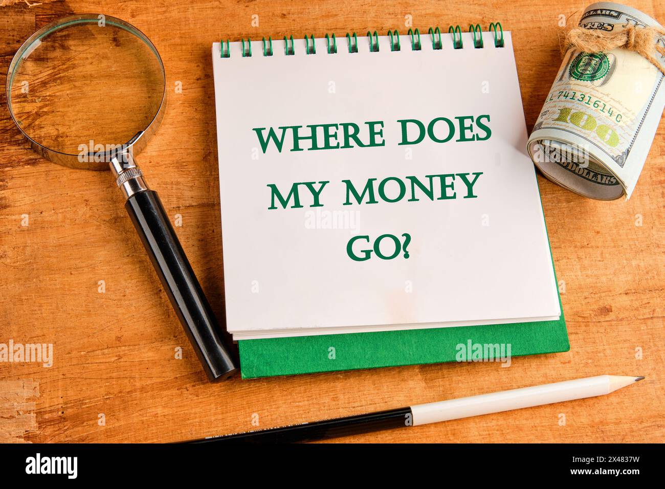 Question WHERE DOES MY MONEY GO on a notebook with a magnifying glass ...