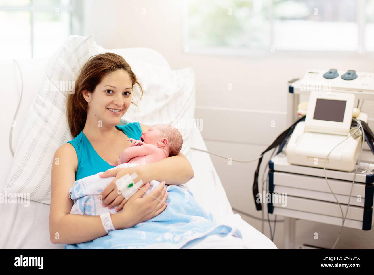 Mother giving birth to a baby. Newborn baby in delivery room. Mom ...
