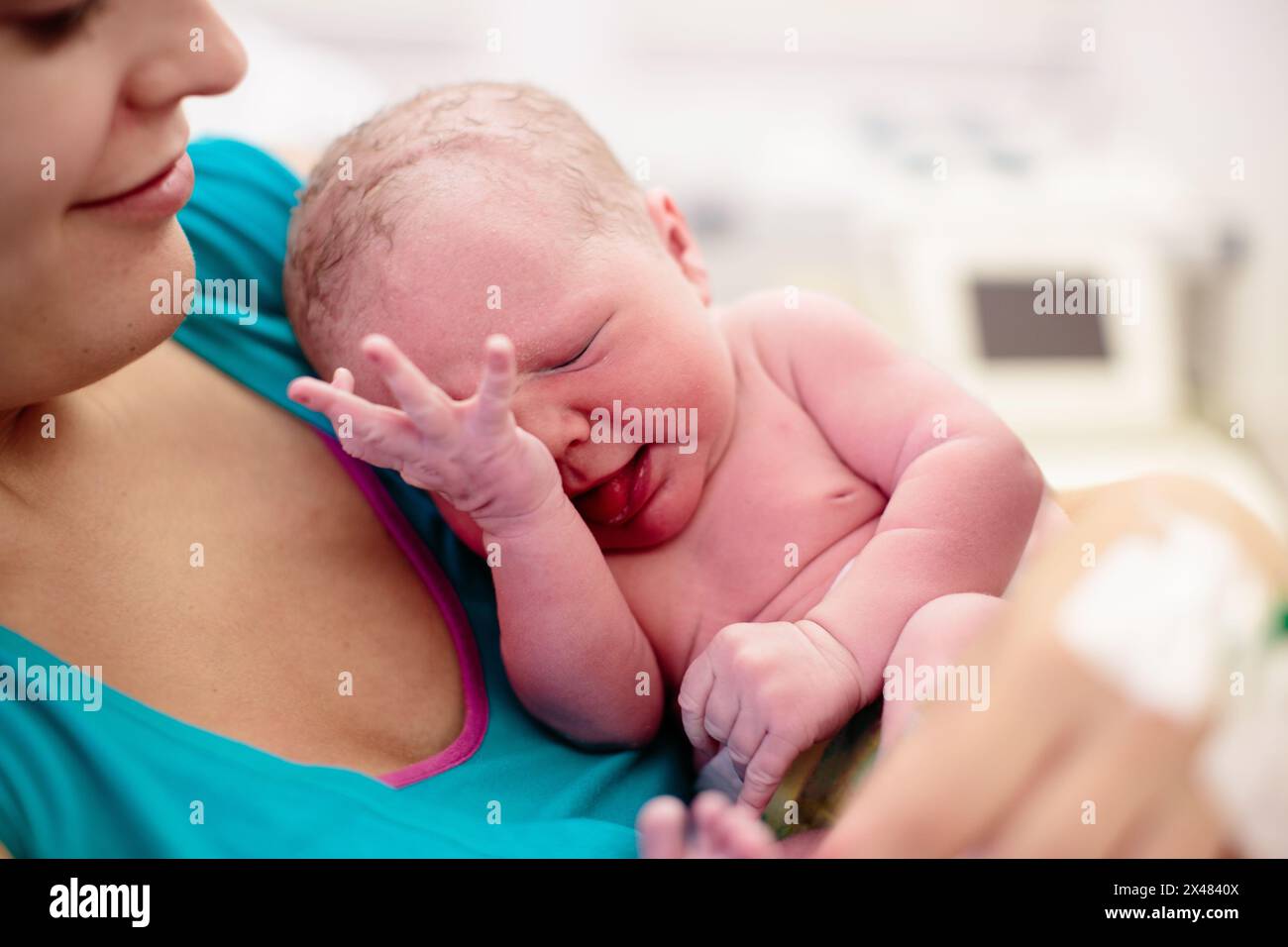 Mother giving birth to a baby. Newborn baby in delivery room. Mom ...