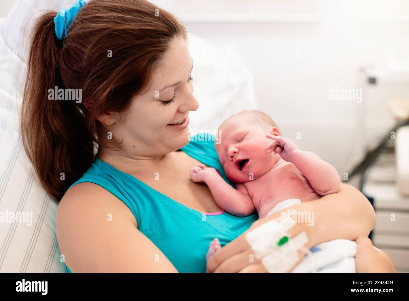 Mother giving birth to a baby. Newborn baby in delivery room. Mom ...