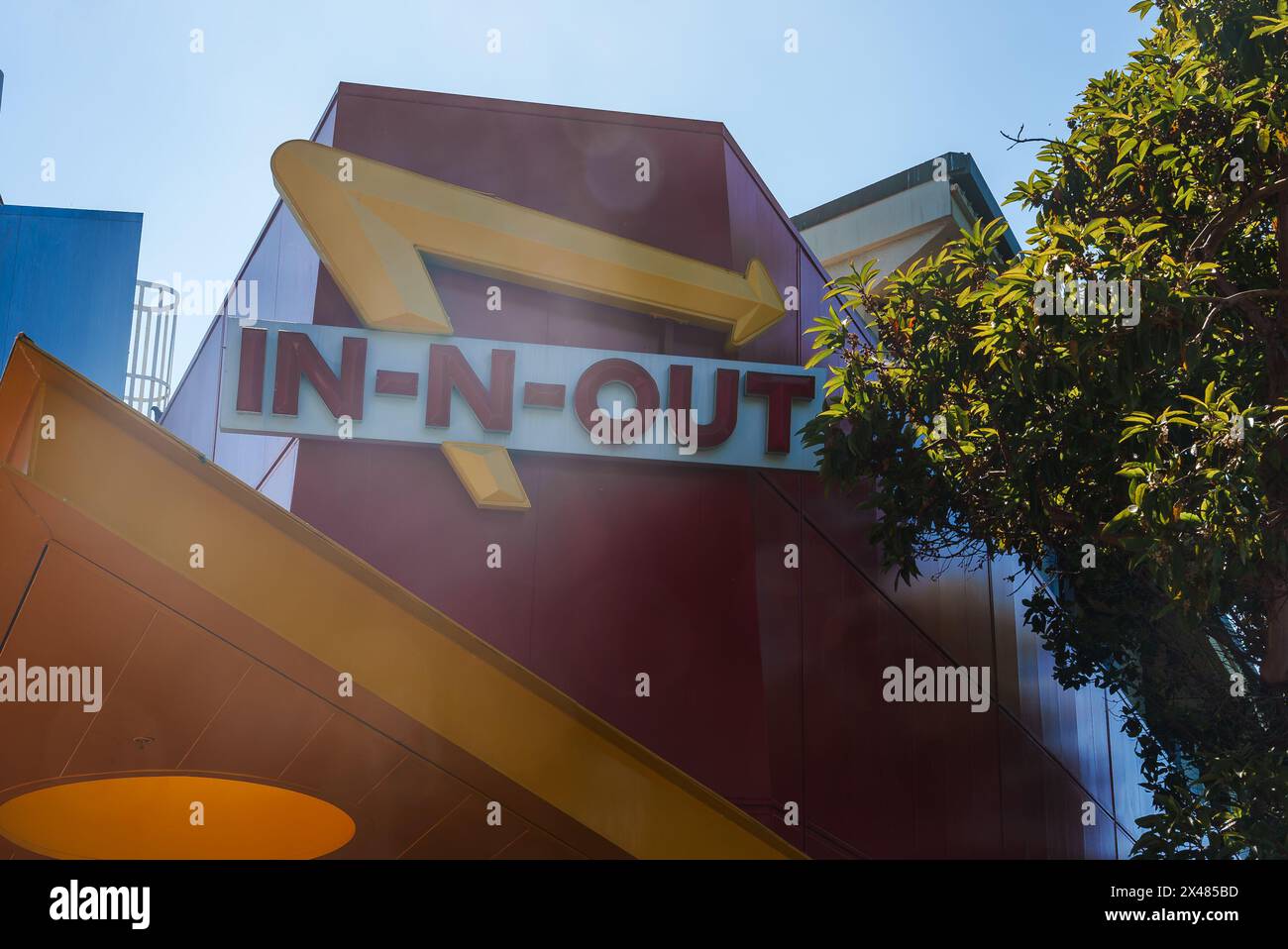 In N Out Burger iconic sign, red background, yellow arrow, building ...