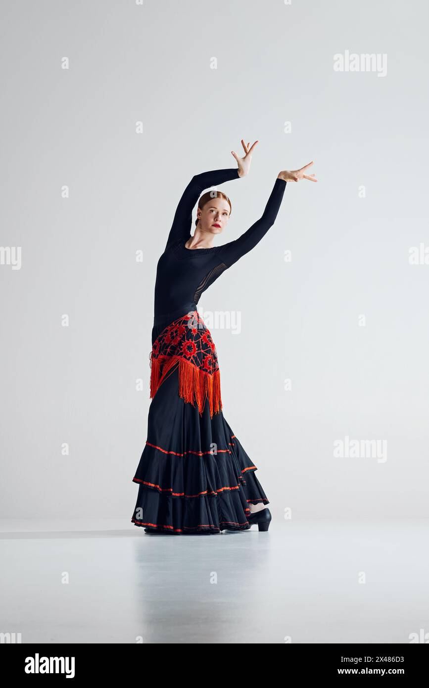 Elegant and intense performance. Tender woman dancing flamenco against ...