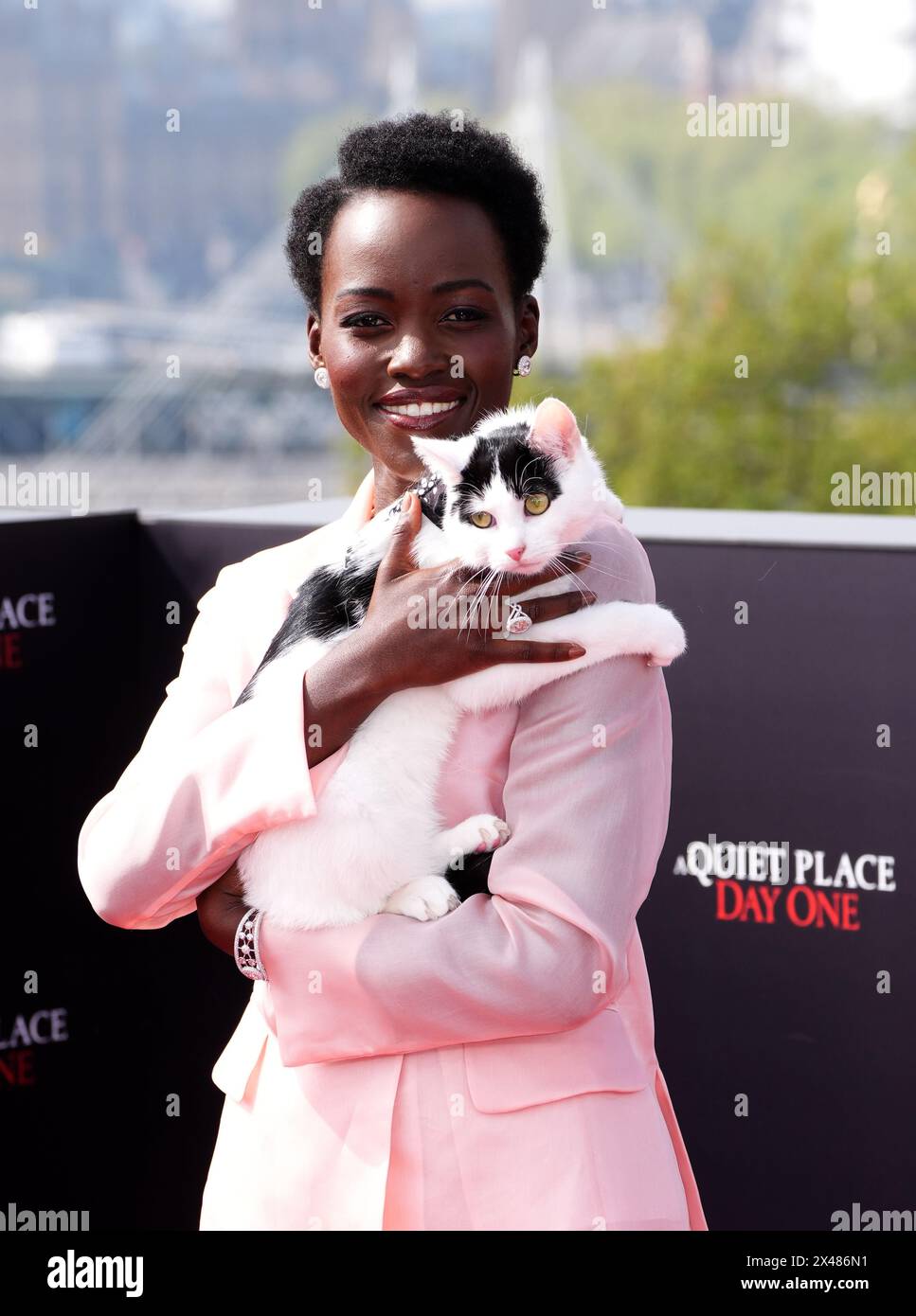 Lupita Nyong'o and cat Schnitzel during a photocall for A Quiet Place ...