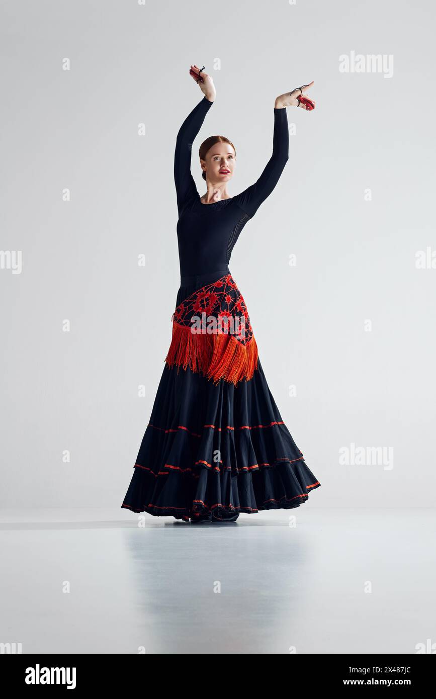 Moment of flamenco magic. Elegant woman in stylish dress standing in ...