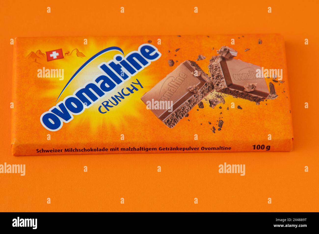 Swiss chocolate from Ovomaltine. Tiles in orange packaging. Sweetness ...