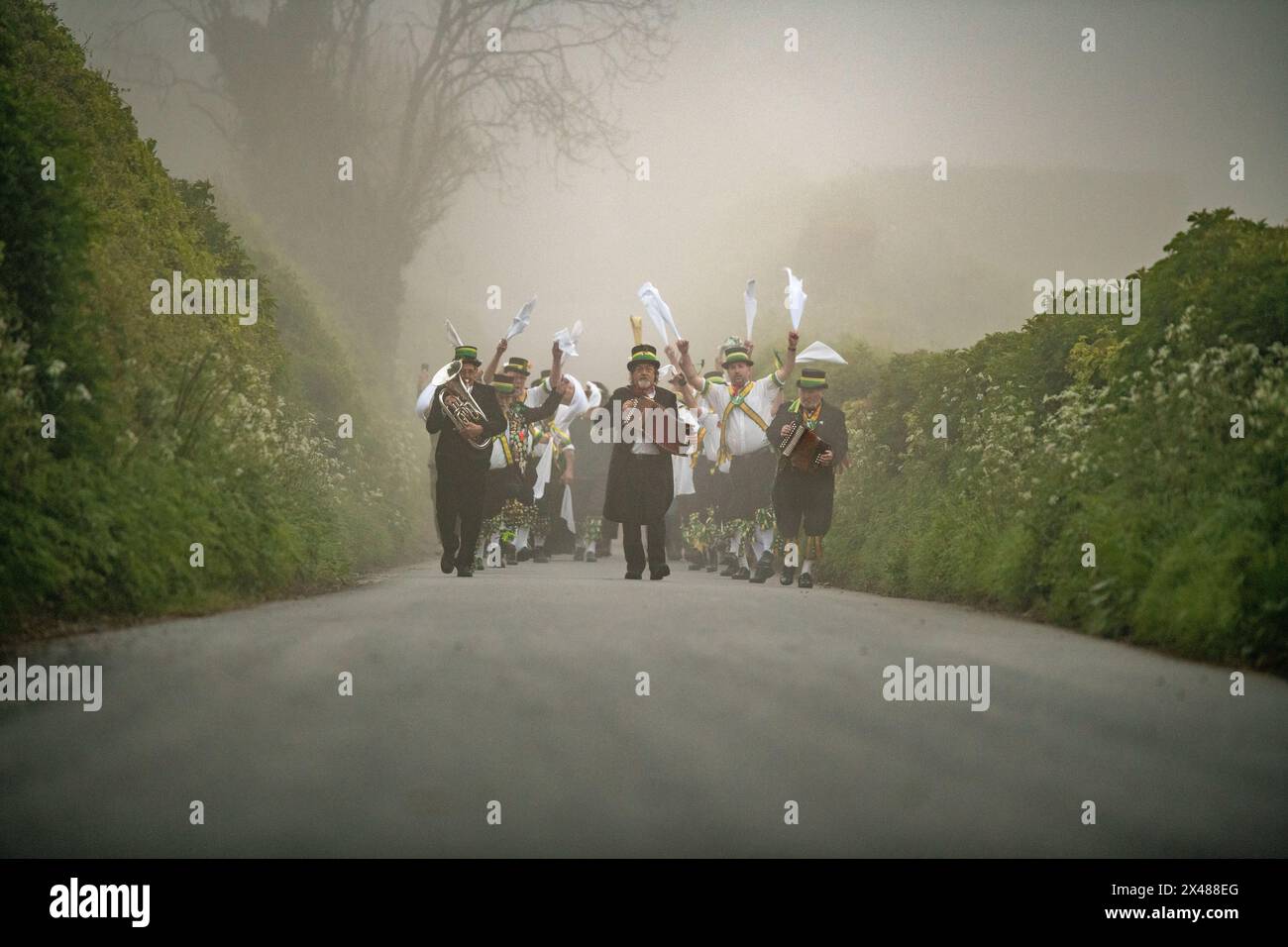 Long Man Morris Dancers perform below the Long Man of Wilmington, East ...