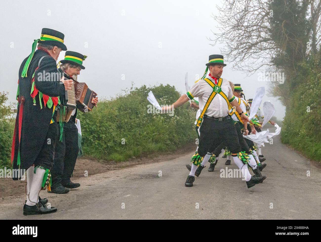 Long Man Morris Dancers perform below the Long Man of Wilmington, East ...