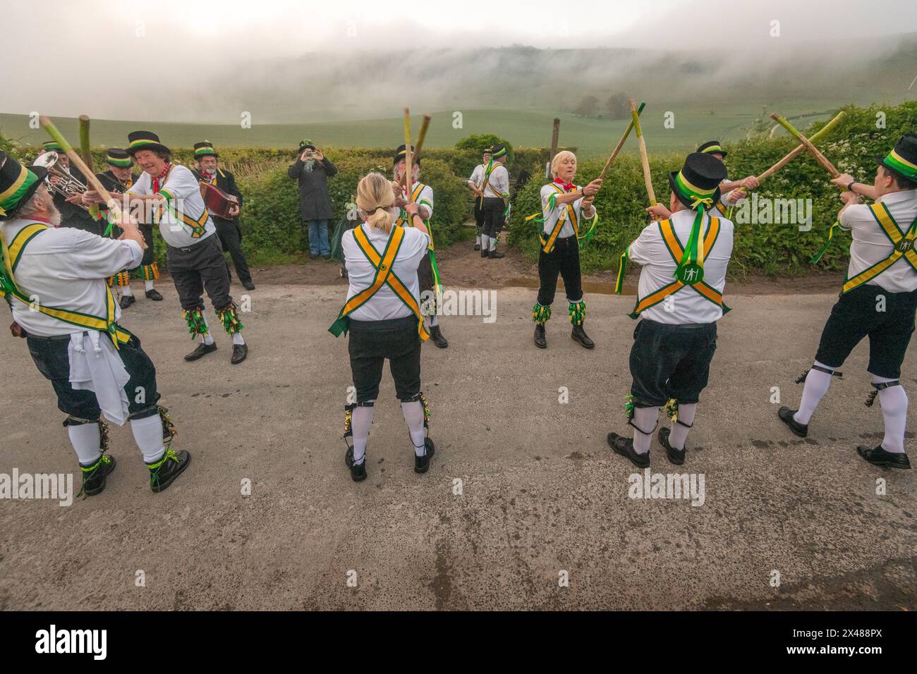 Long Man Morris Dancers perform below the Long Man of Wilmington, East ...
