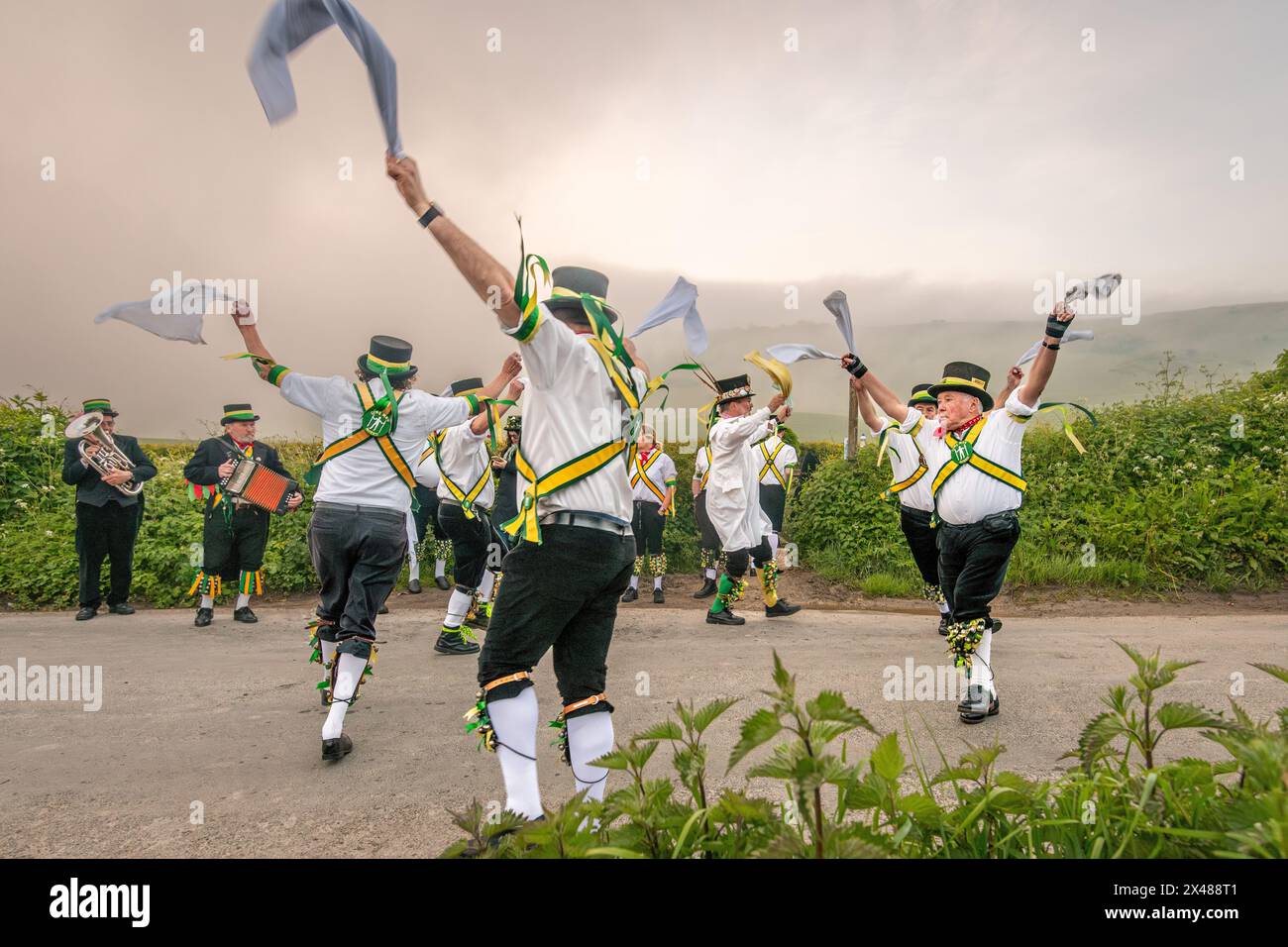 Long Man Morris Dancers perform below the Long Man of Wilmington, East ...
