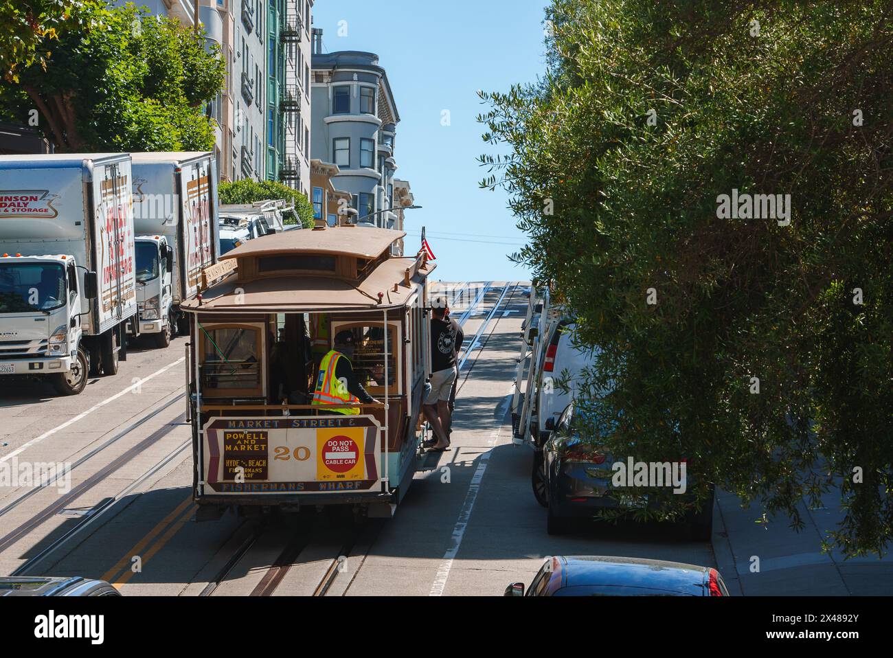 Classic San Francisco scene iconic cable car ascending steep street ...