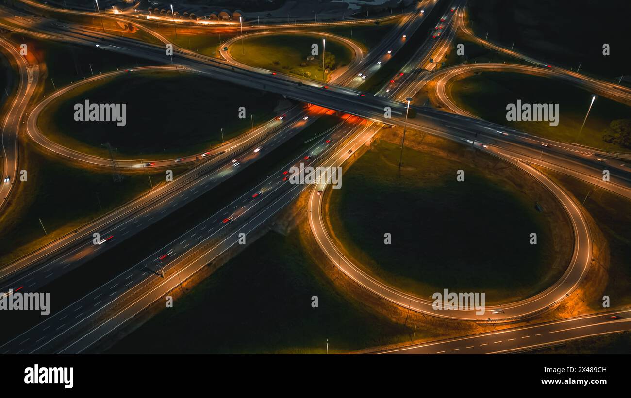 A modern flyover road junction in a large megapolis at night ...