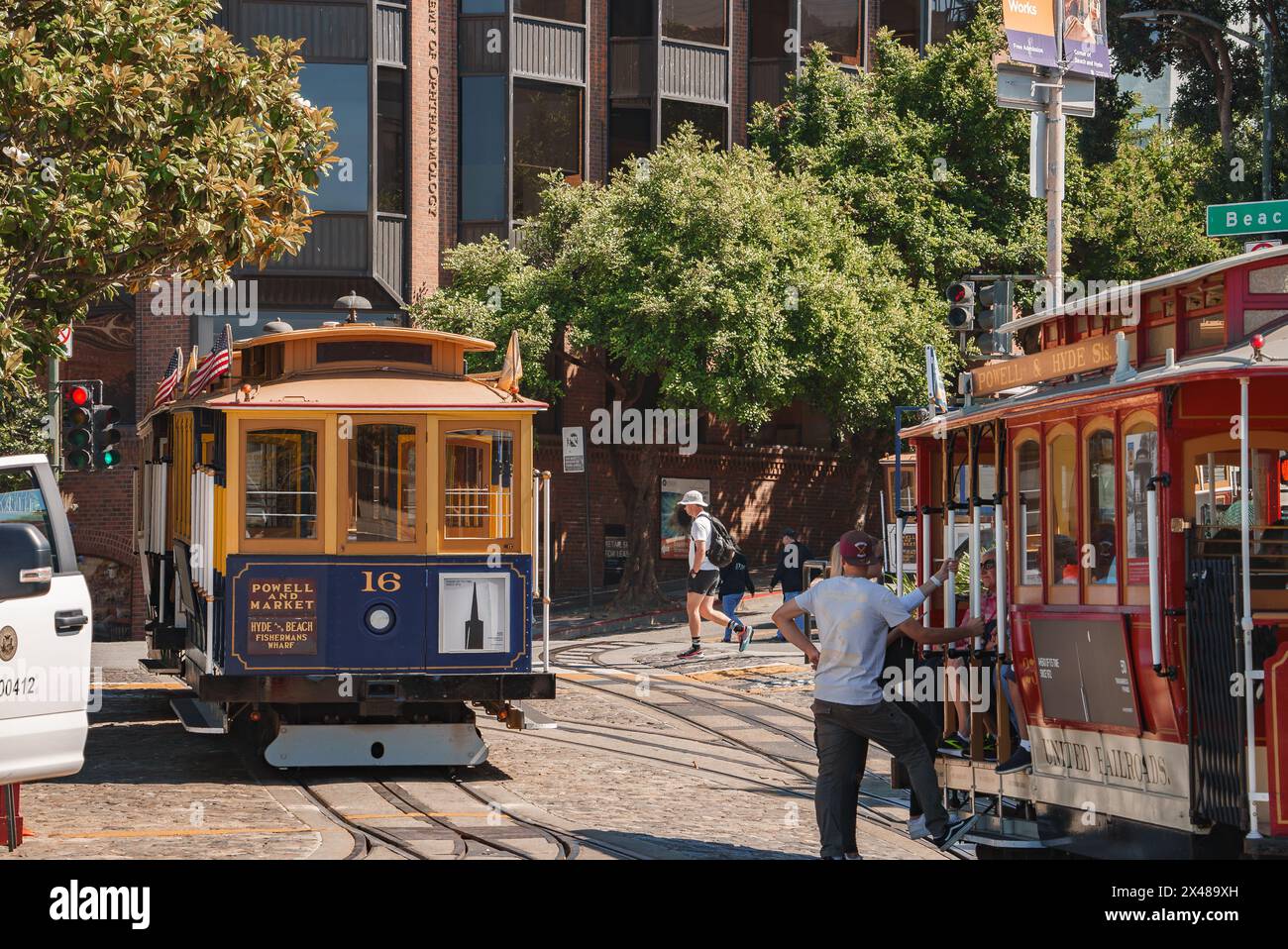 Vibrant San Francisco street scene with iconic cable cars, operator ...