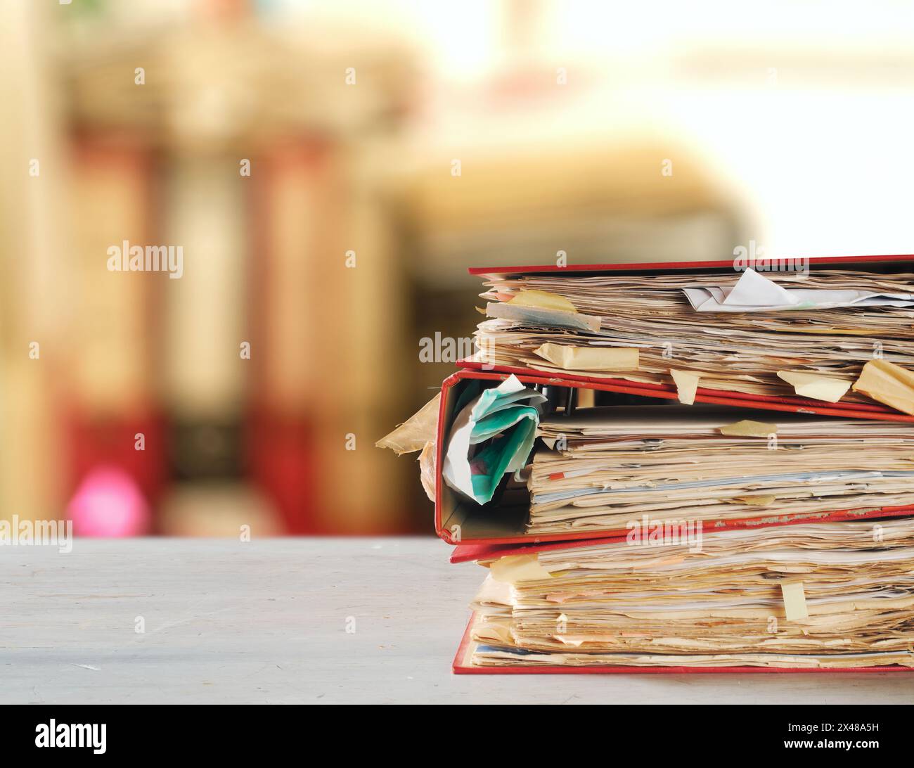 stack of dusty messy file folders with narrow depth of field, blurred ...