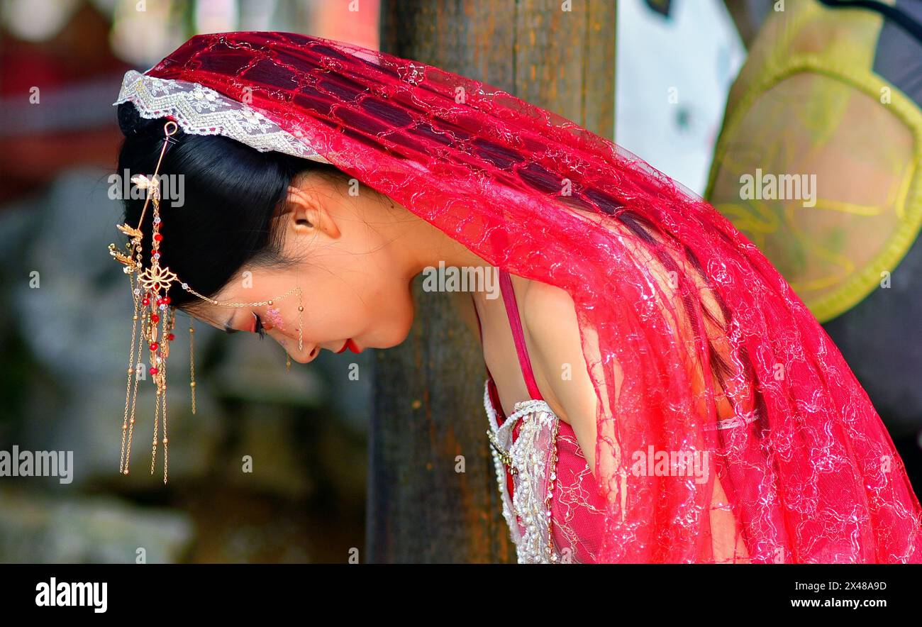 Beautiful Chinese girl in traditional red ethnic minority costume in a ...