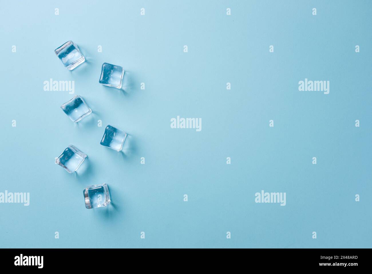 top view of ice cubes of different sizes on blue background Stock Photo ...