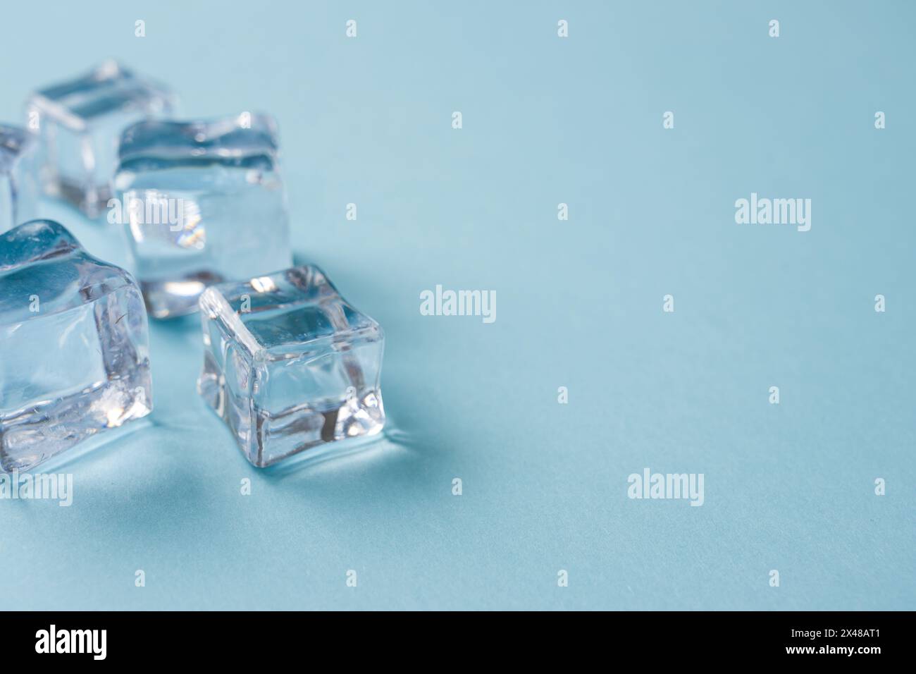 top view of ice cubes of different sizes on blue background Stock Photo ...