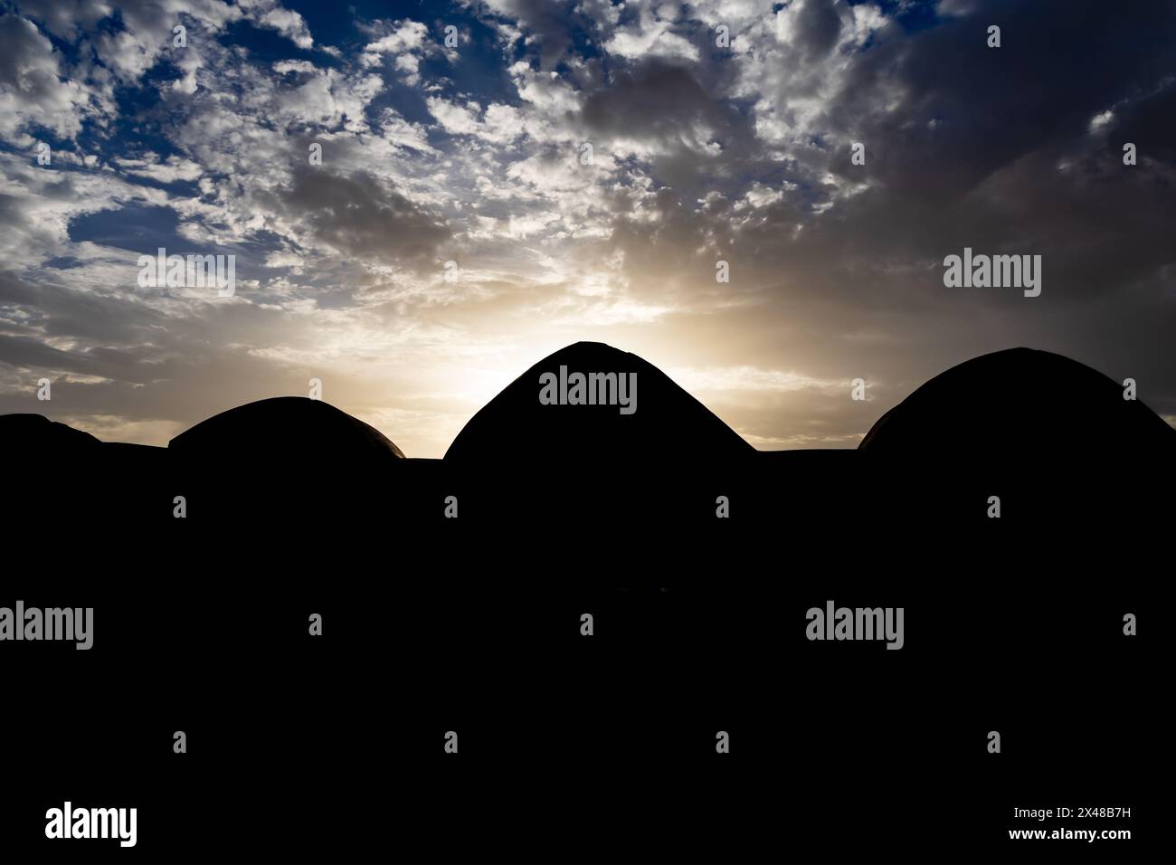 backlit shot of ancient fort wall and dramatic blue sky at evening from ...