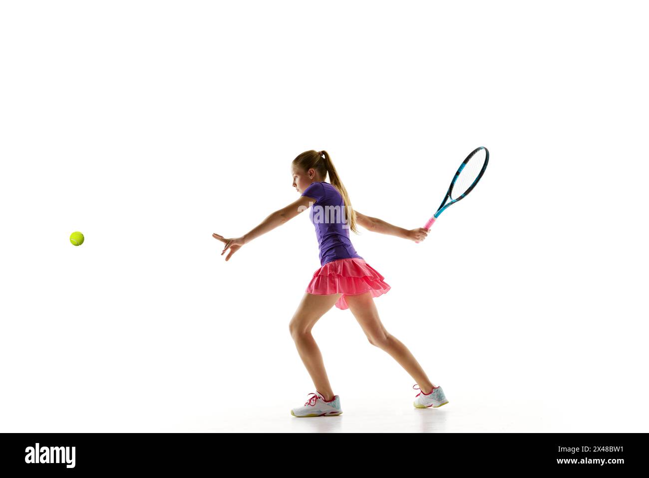 Dynamic portrait of athletic teenage girl taking passing shot to ...