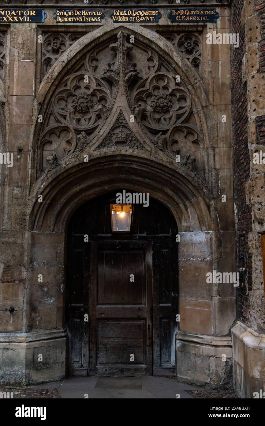 Old carved doorway into Trinity College Great Gate with a lantern ...