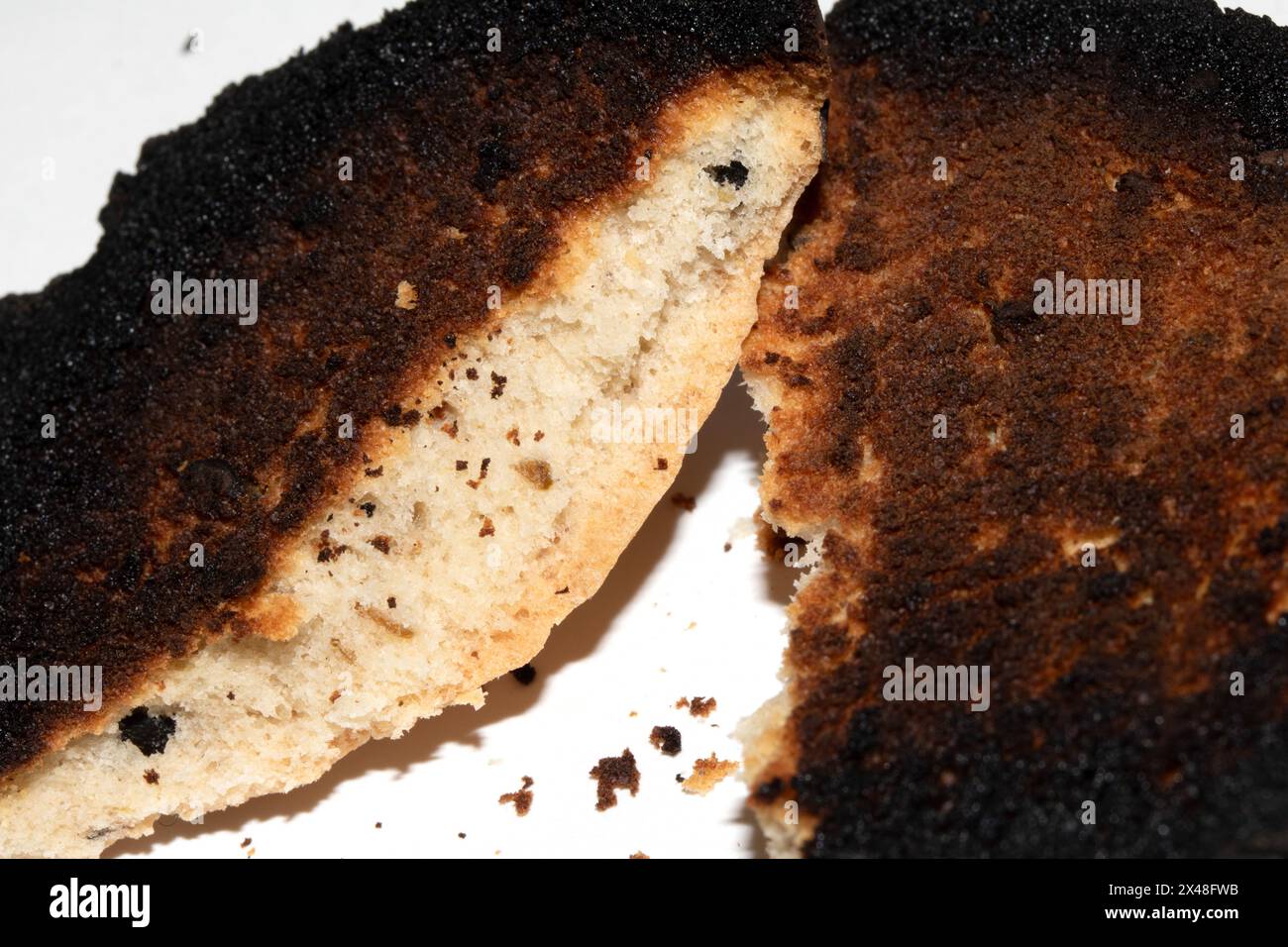 A Very Burnt Bread Roll Torn or Cut in Half Toast Close Up Texture ...