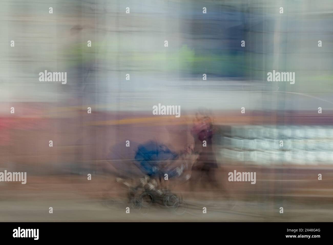 Abstract image of a woman pushing a pram in city captured using ICM ...