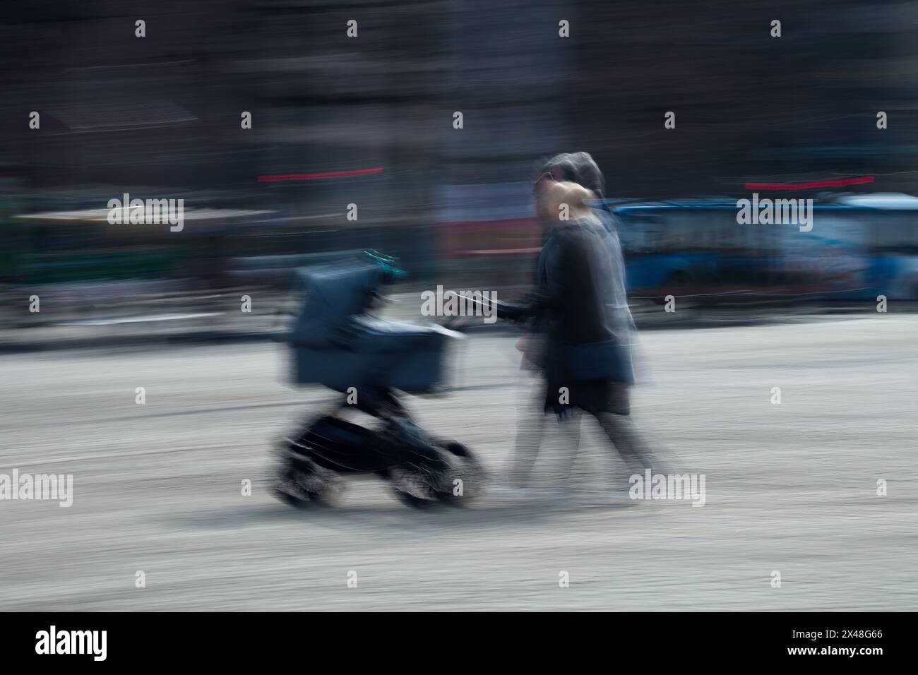 Abstract image of a couple pushing a pram in city captured using ICM ...