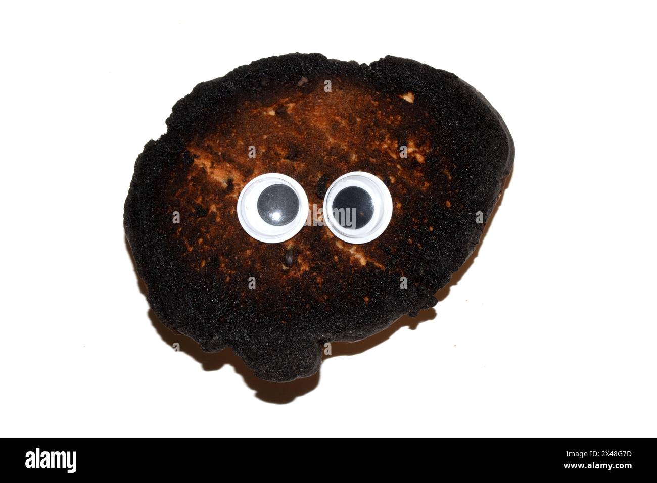 A Funny Burnt Toast Bread Roll With Googly Wobble Eyes Stock Photo - Alamy