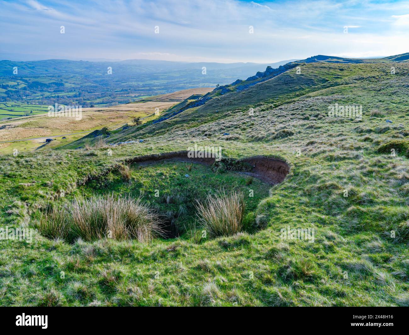 Sink hole in limestone strata on the Black Mountain of the Brecon ...