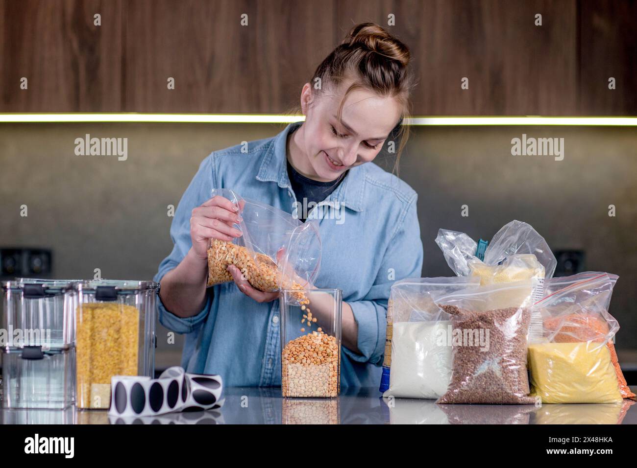 Layout and sorting of food products. Woman uses containers to organize ...