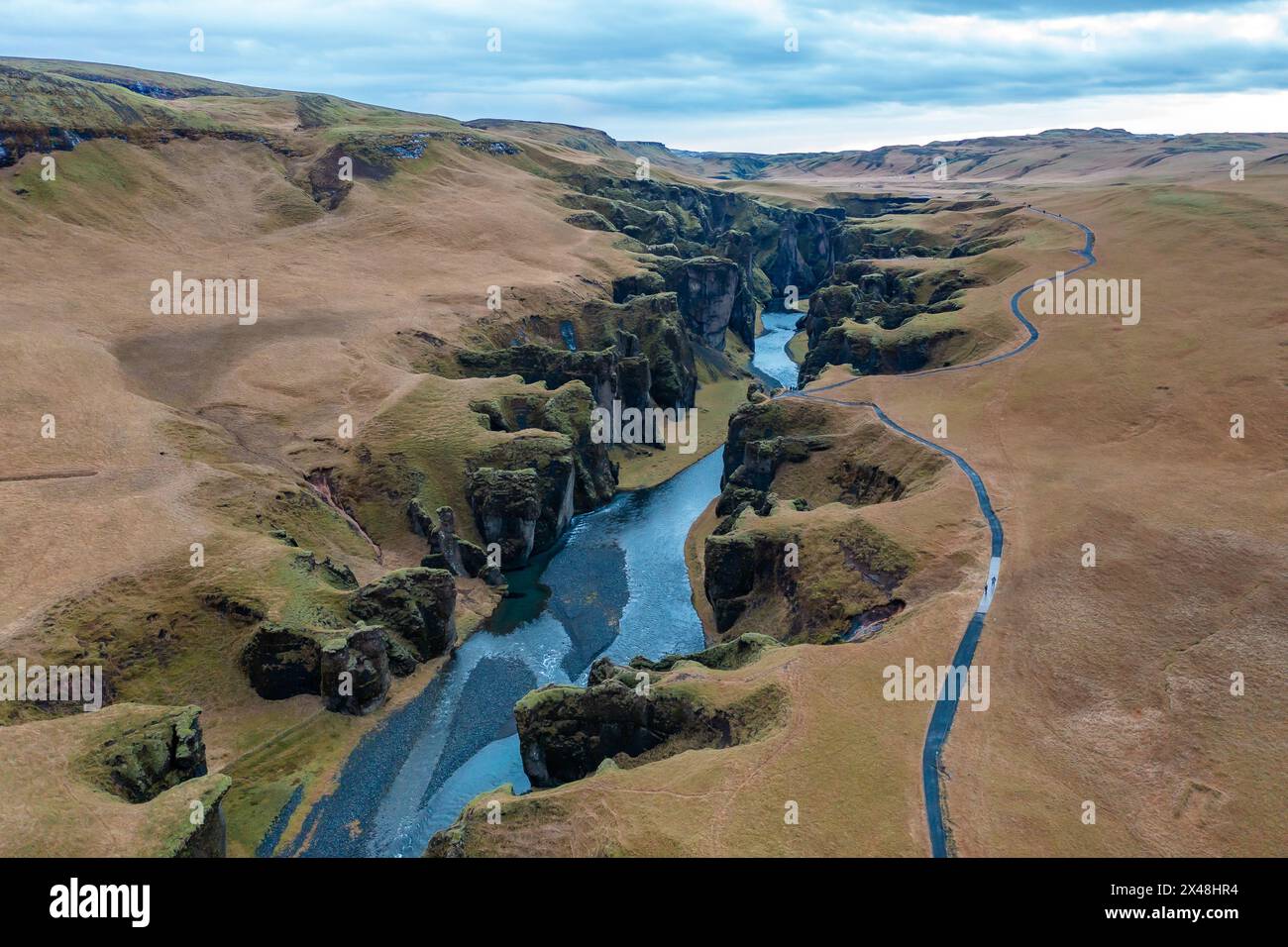 Vertical top view between hills in Iceland winding blue river, branch ...