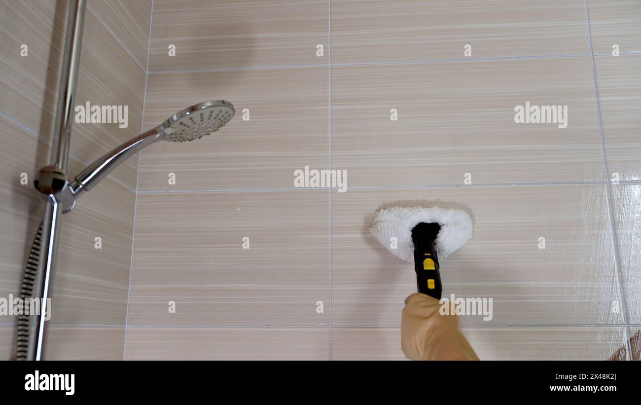 Cleaning bathroom tiles with steam. Cleaning and disinfecting the ...