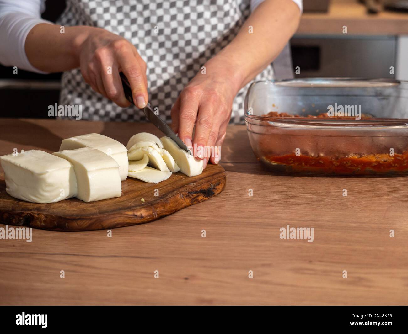 Hands cutting big mozzarella cheese hi-res stock photography and images ...