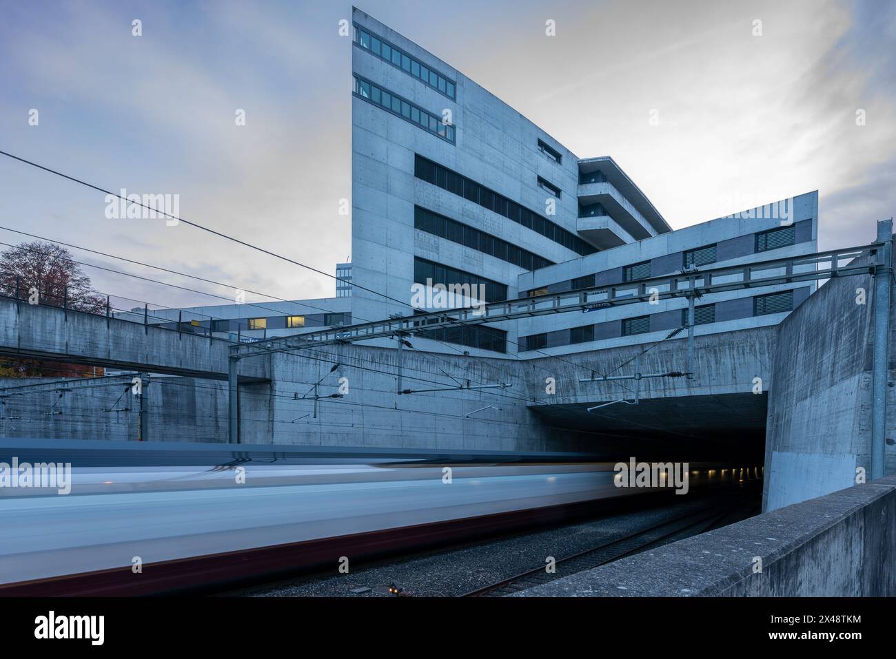 Ship like building with train tunnel and blurred train with inner ...