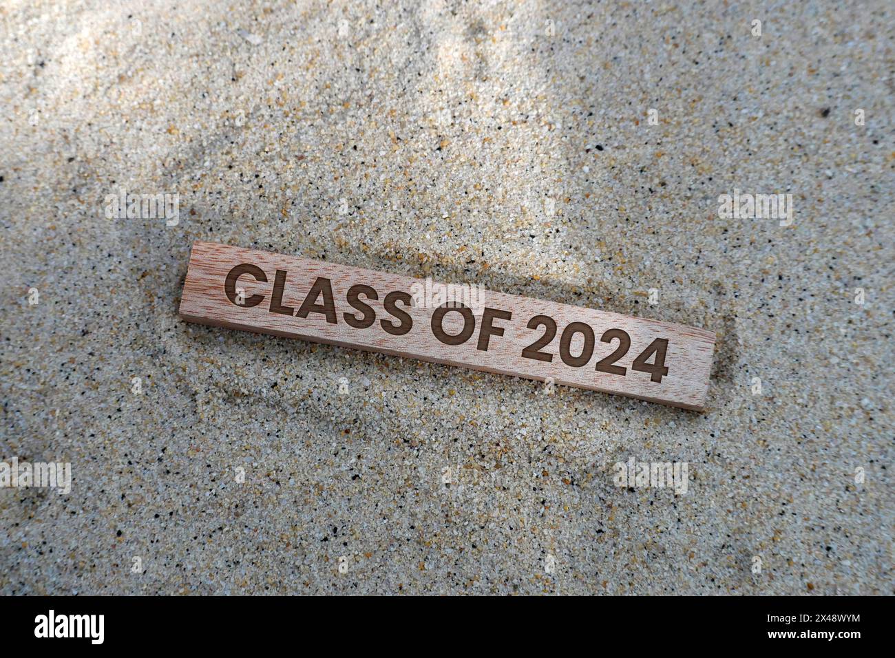 wooden blocks on beach sand with class of 2024 engravings Stock Photo ...