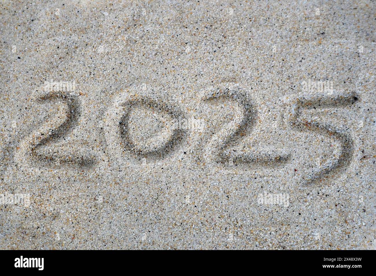 handwritten text of 2025 in the sand Stock Photo - Alamy
