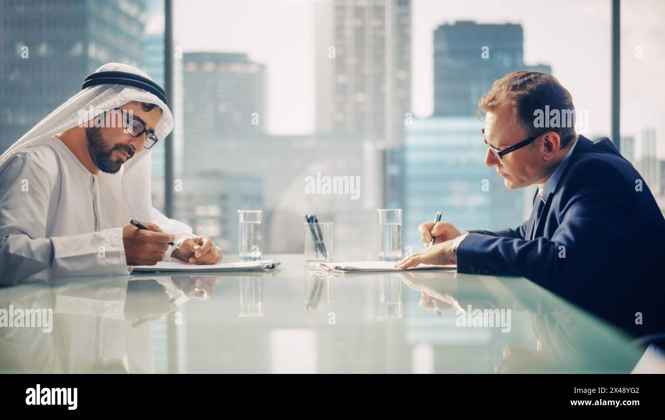 Two Businessmen with Different Nationalities Sitting in Office and ...