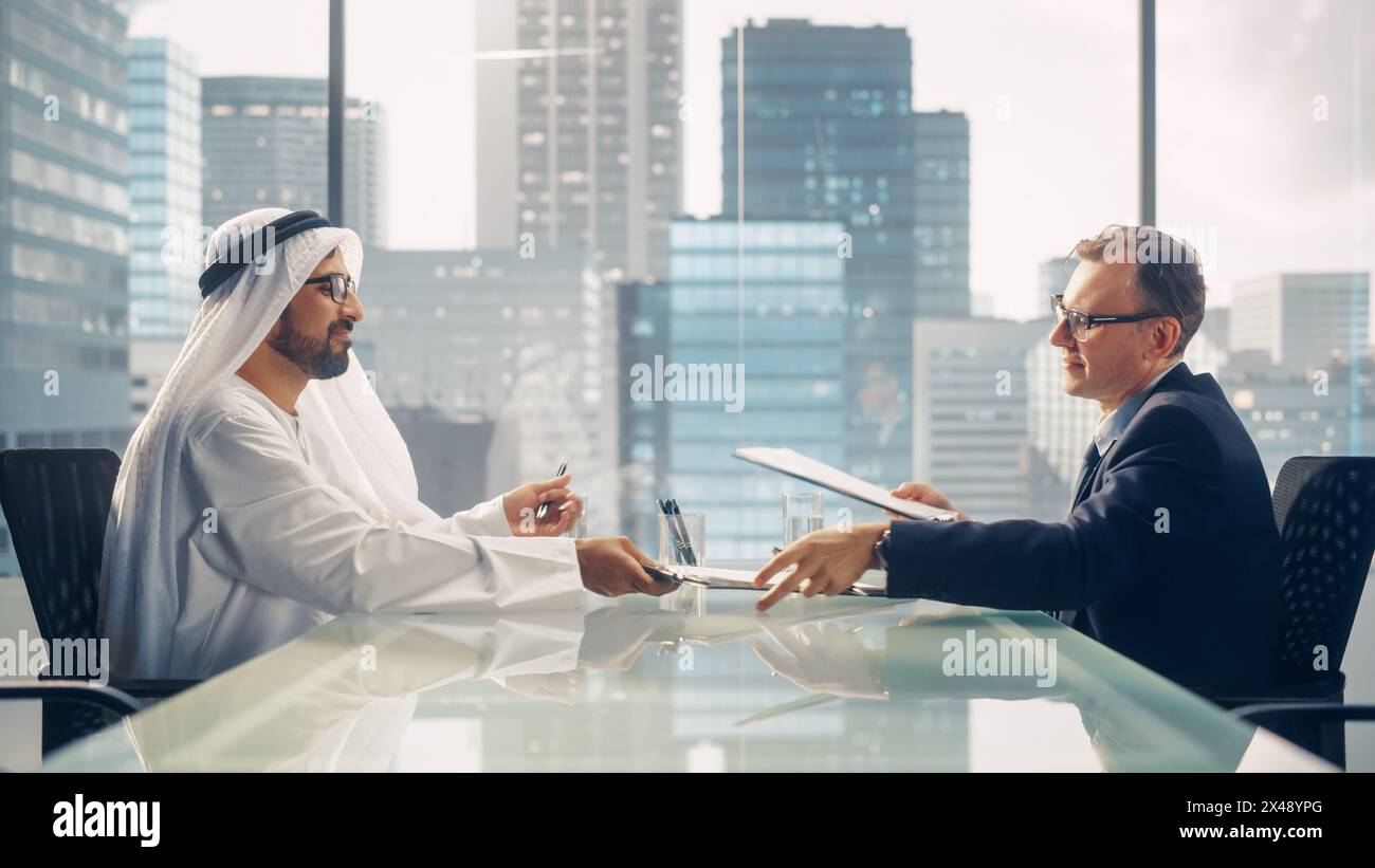 Two Businessmen with Different Nationalities Sitting in Office and ...