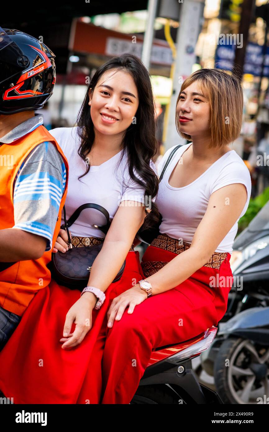 Two Pretty Thai Massage Girls Ride A Motorbike Taxi Through The Streets Of Pattaya Thailand