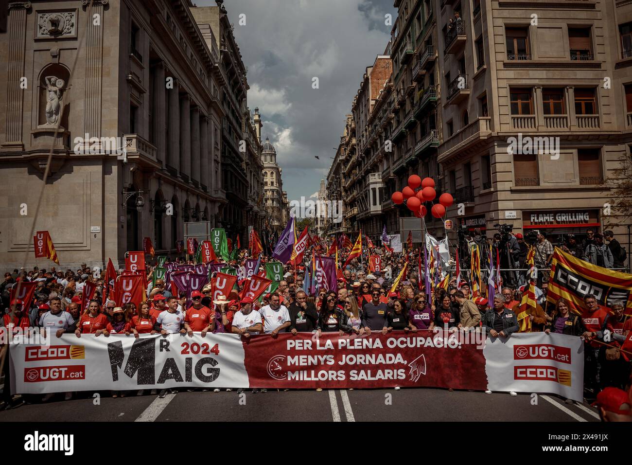 Barcelona, Spain. 1st May, 2024. Protesters holding flags march behind ...
